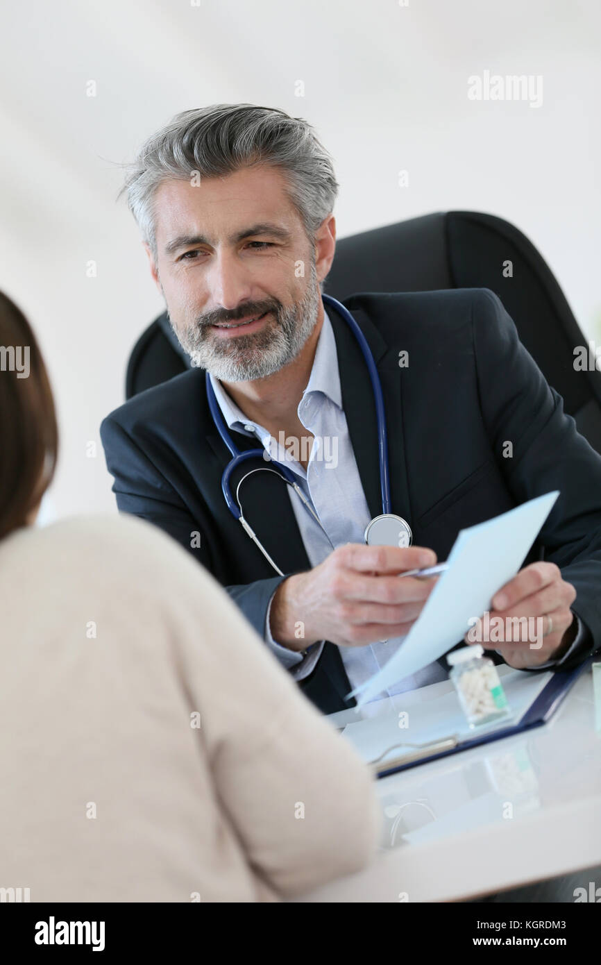 Doctor giving prescription to patient Stock Photo - Alamy