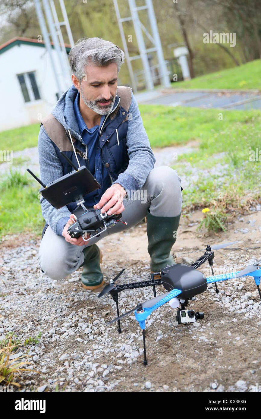 Man operating a drone with remote control Stock Photo - Alamy