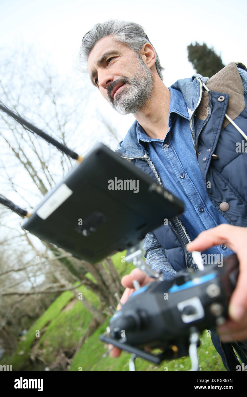 Man operating a drone with remote control Stock Photo - Alamy