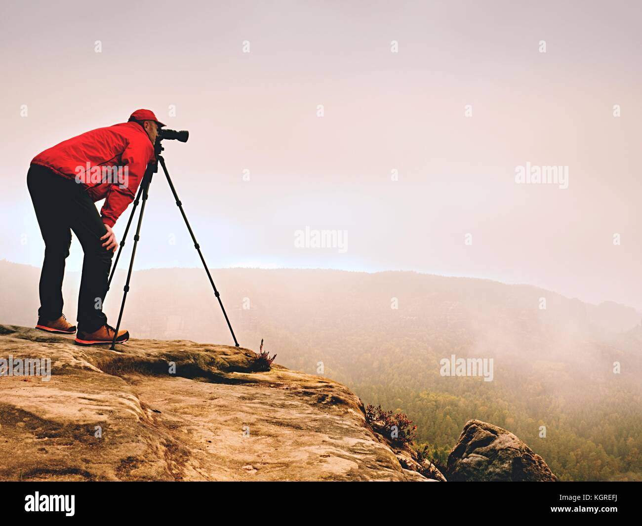 Professional photographer work on mountain peak. Nature photographer ...