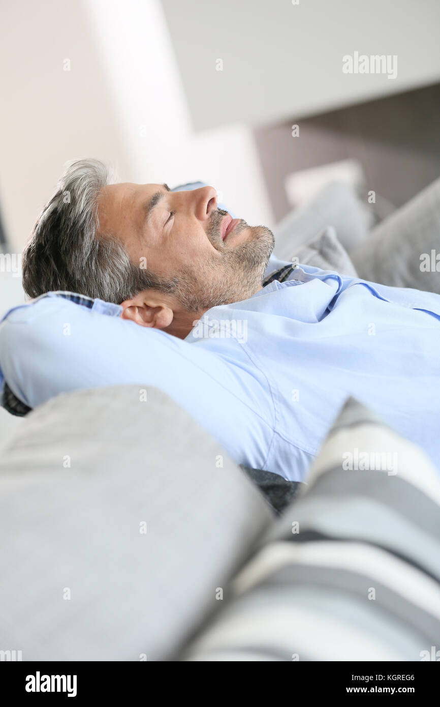 Middle-aged man having a restful moment relaxing in sofa Stock Photo ...