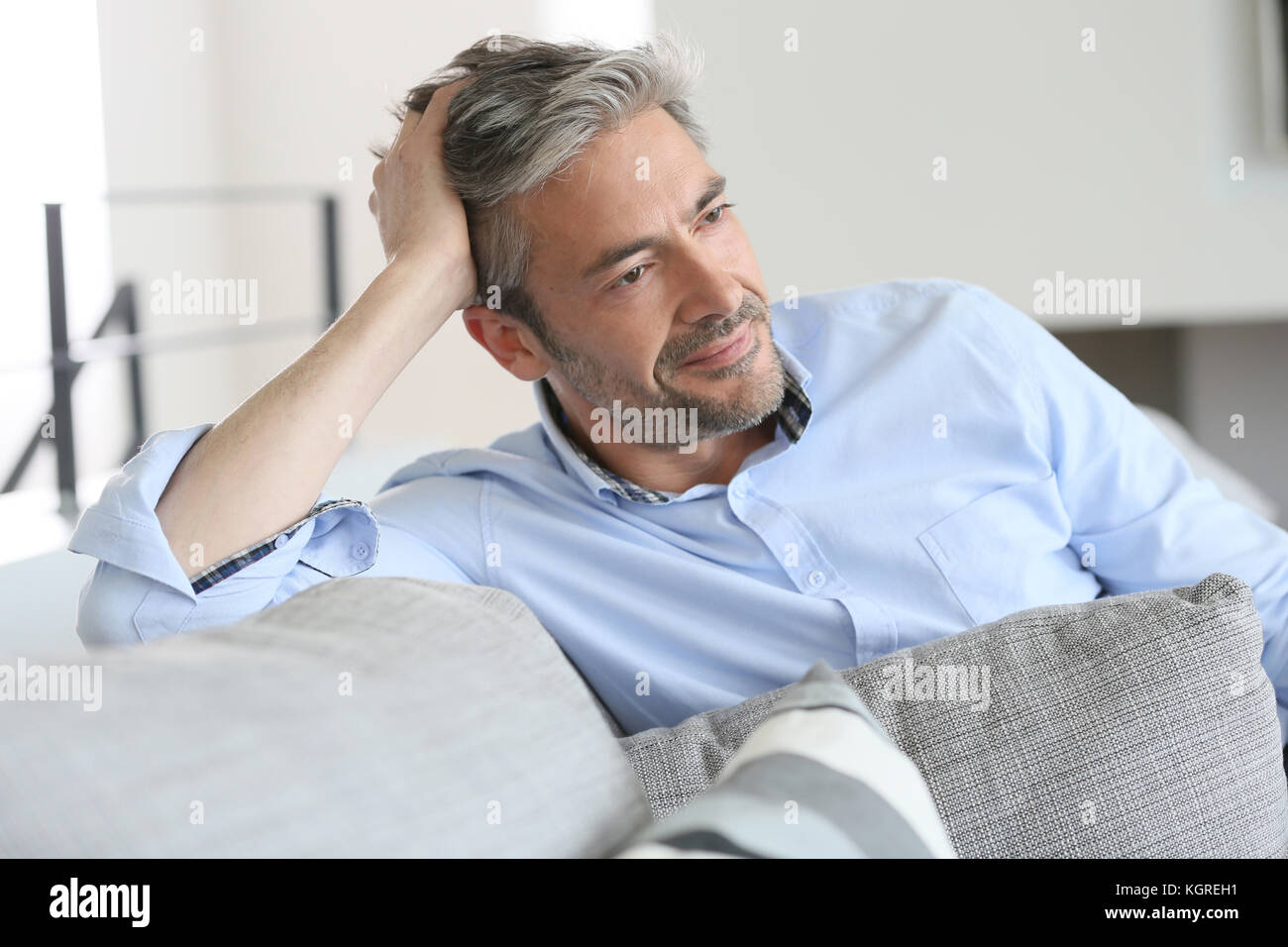Smiling handsome 45-year-old man relaxing at home Stock Photo - Alamy