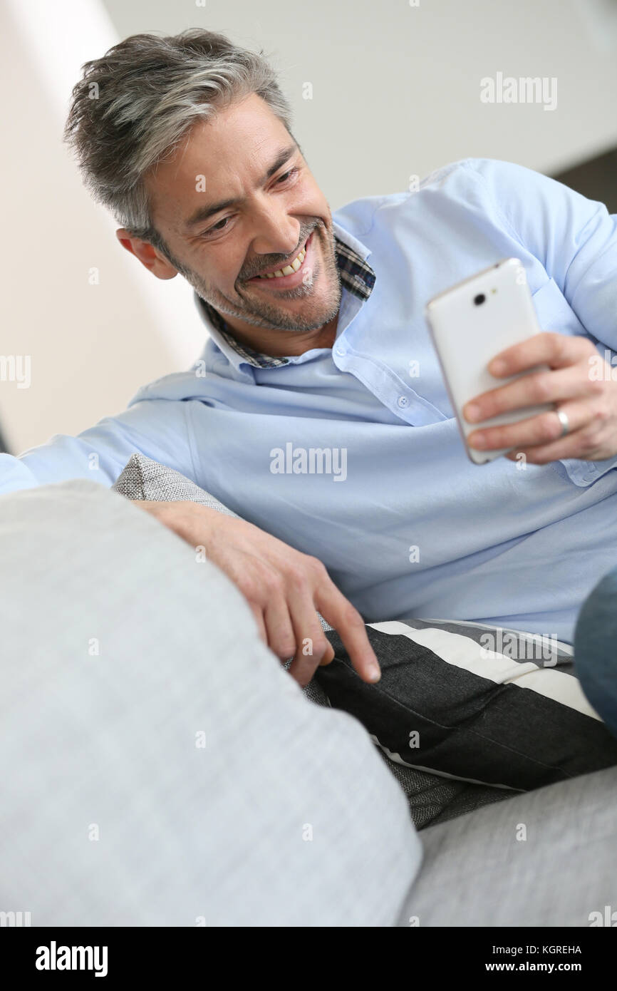 Mature man sending message with smartphone Stock Photo - Alamy