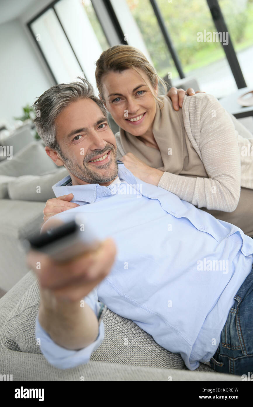 Middle-aged couple in living-room watching television Stock Photo - Alamy