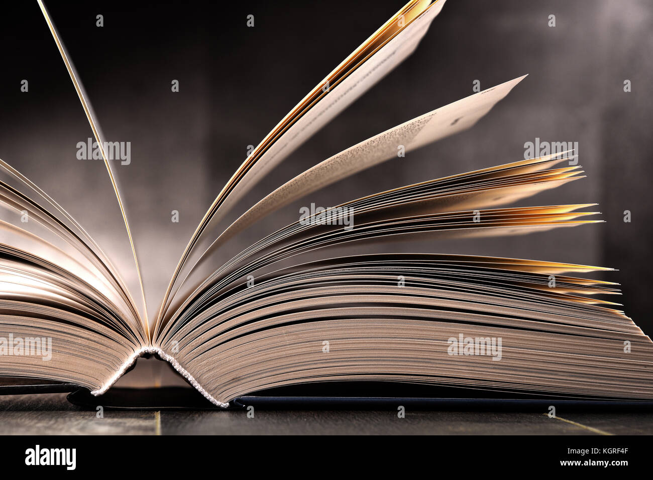 Composition with open book on the table Stock Photo - Alamy