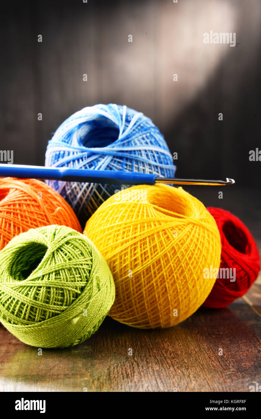 Colorful yarn for crocheting and hook on wooden table Stock Photo - Alamy