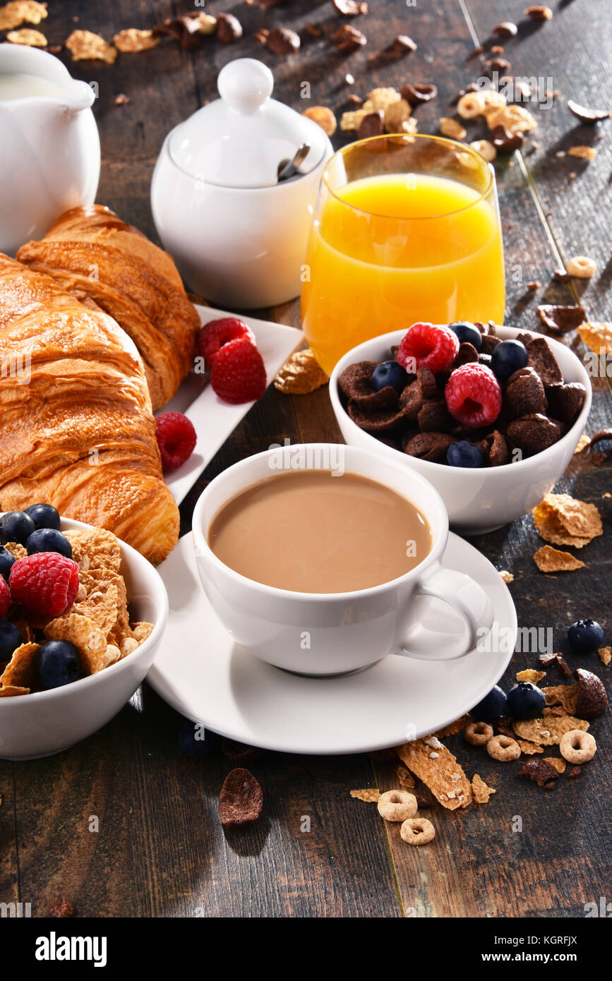 Breakfast served with coffee, orange juice, croissants, cereals and ...