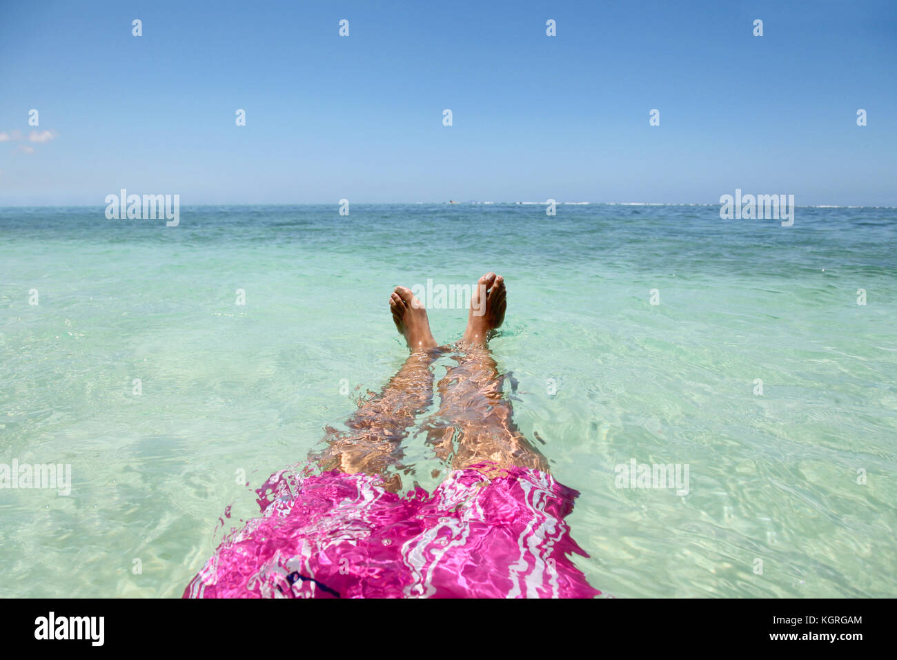 Closeup of man's feet floating in blue lagoon water Stock Photo - Alamy