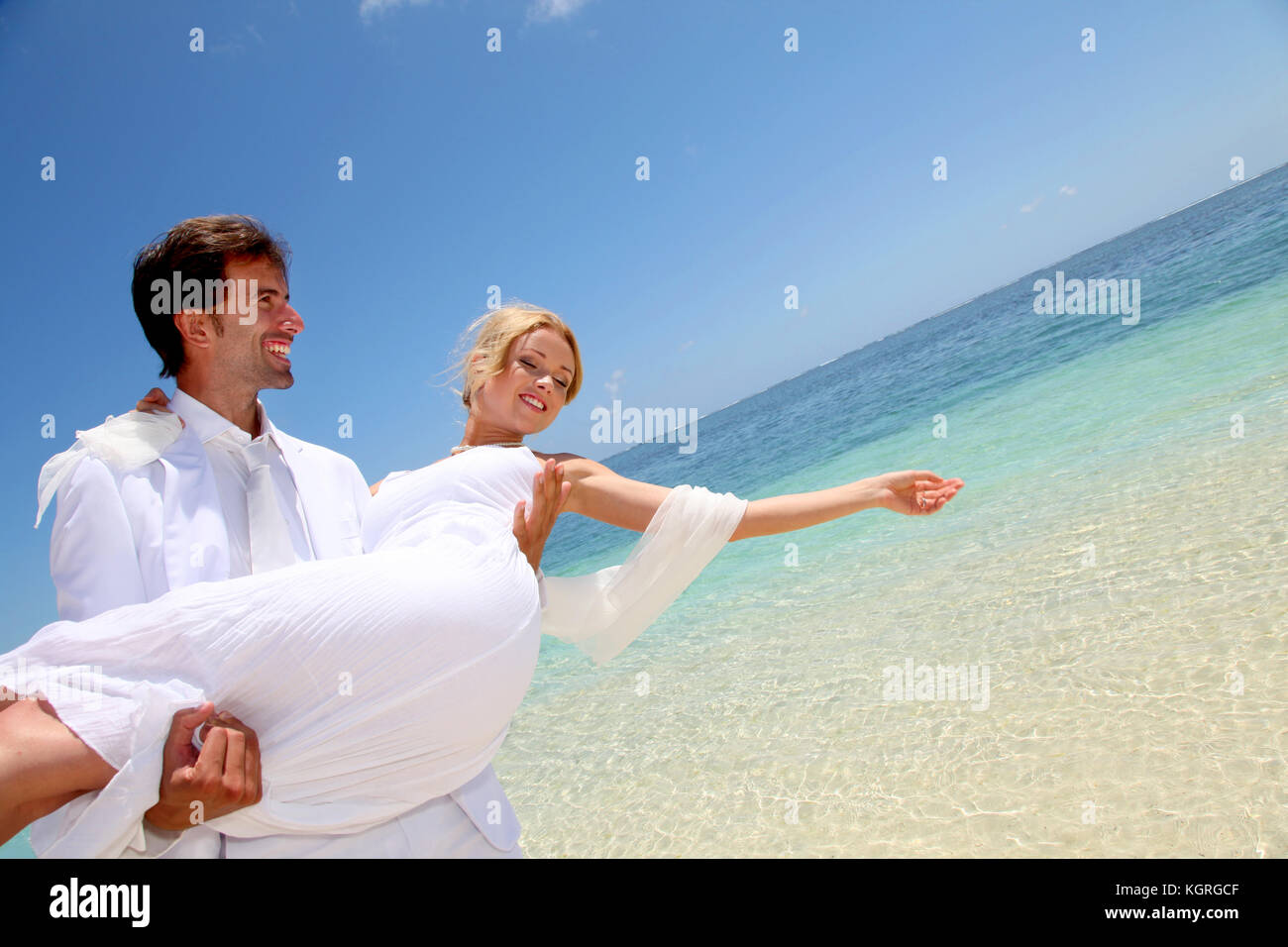 Groom carrying bride in arms hi-res stock photography and images - Alamy