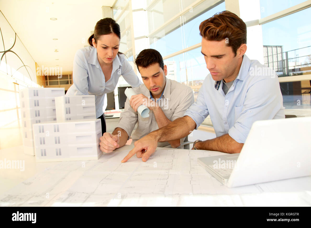 Team of architects working on project Stock Photo - Alamy