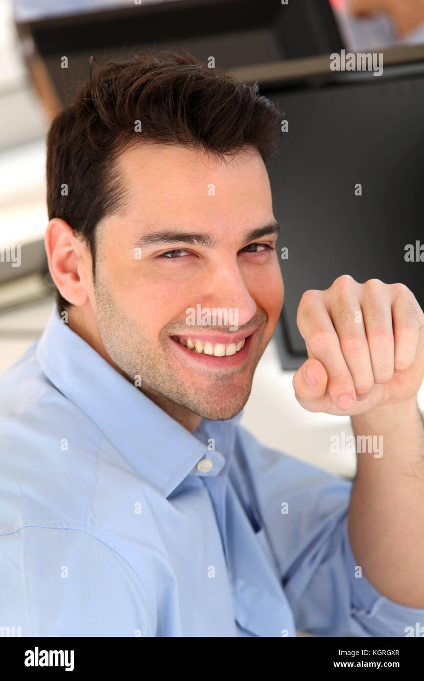 Smiling trader in front of desktop computer Stock Photo - Alamy