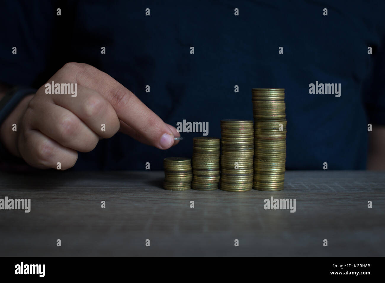 Man stacking money as concept for success or savings, investment and ...