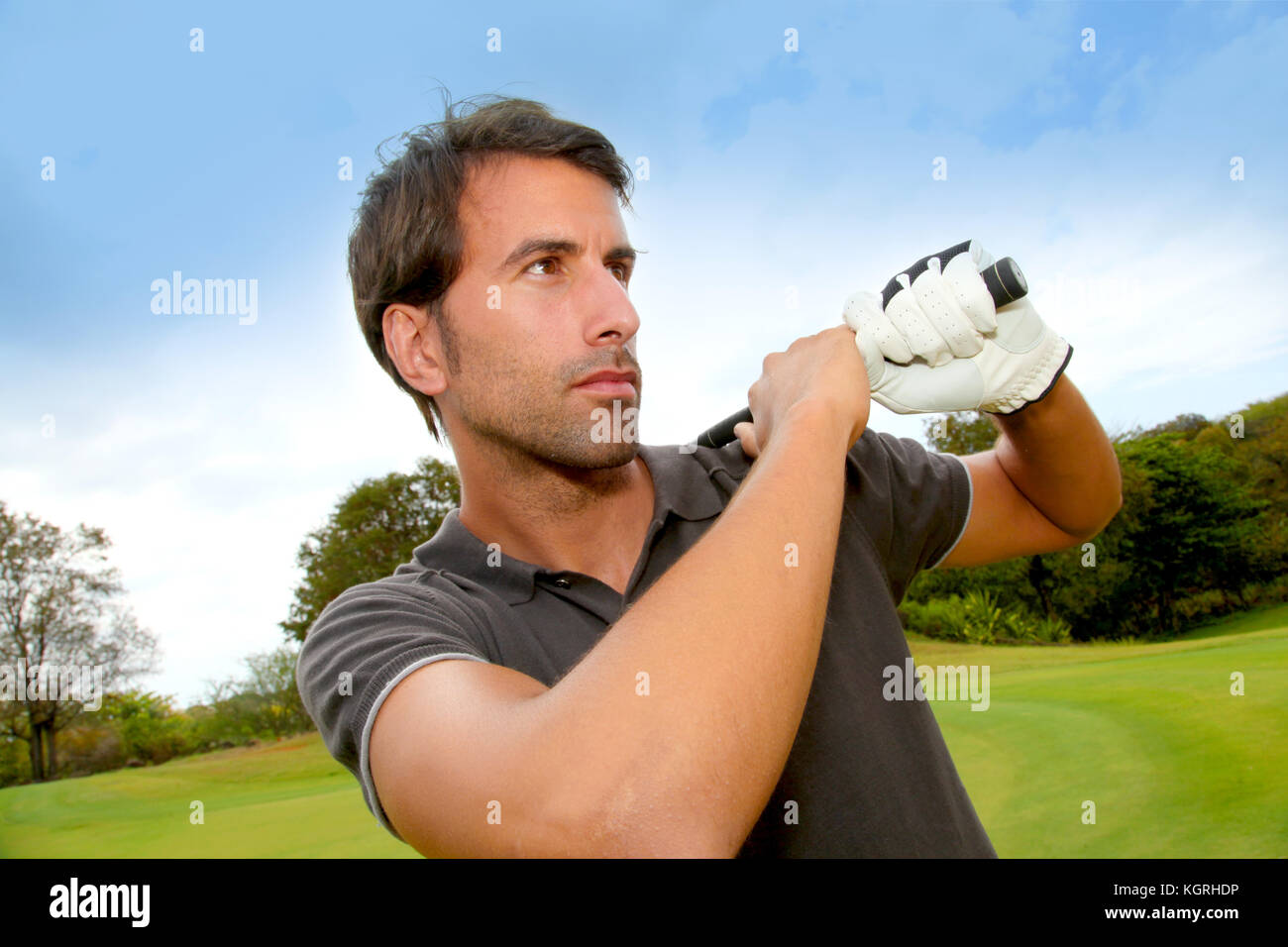 Portrait of man holding golf club Stock Photo - Alamy