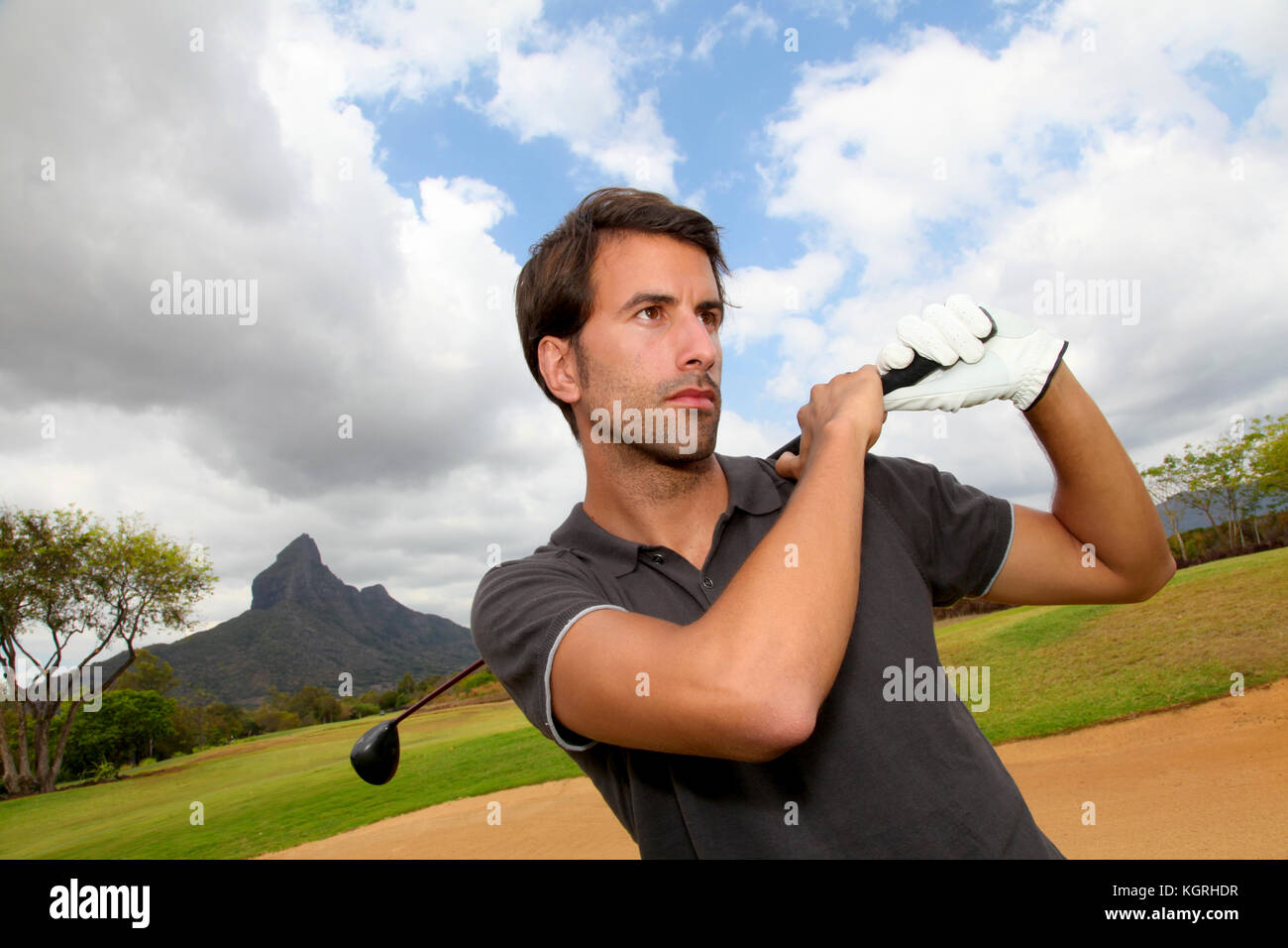 Portrait of man holding golf club Stock Photo - Alamy