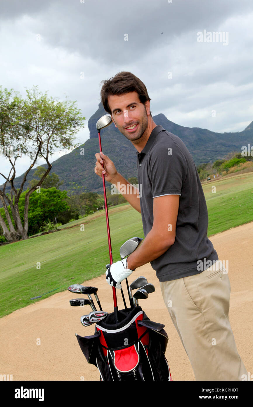 Man standing on golf course with equipment Stock Photo - Alamy