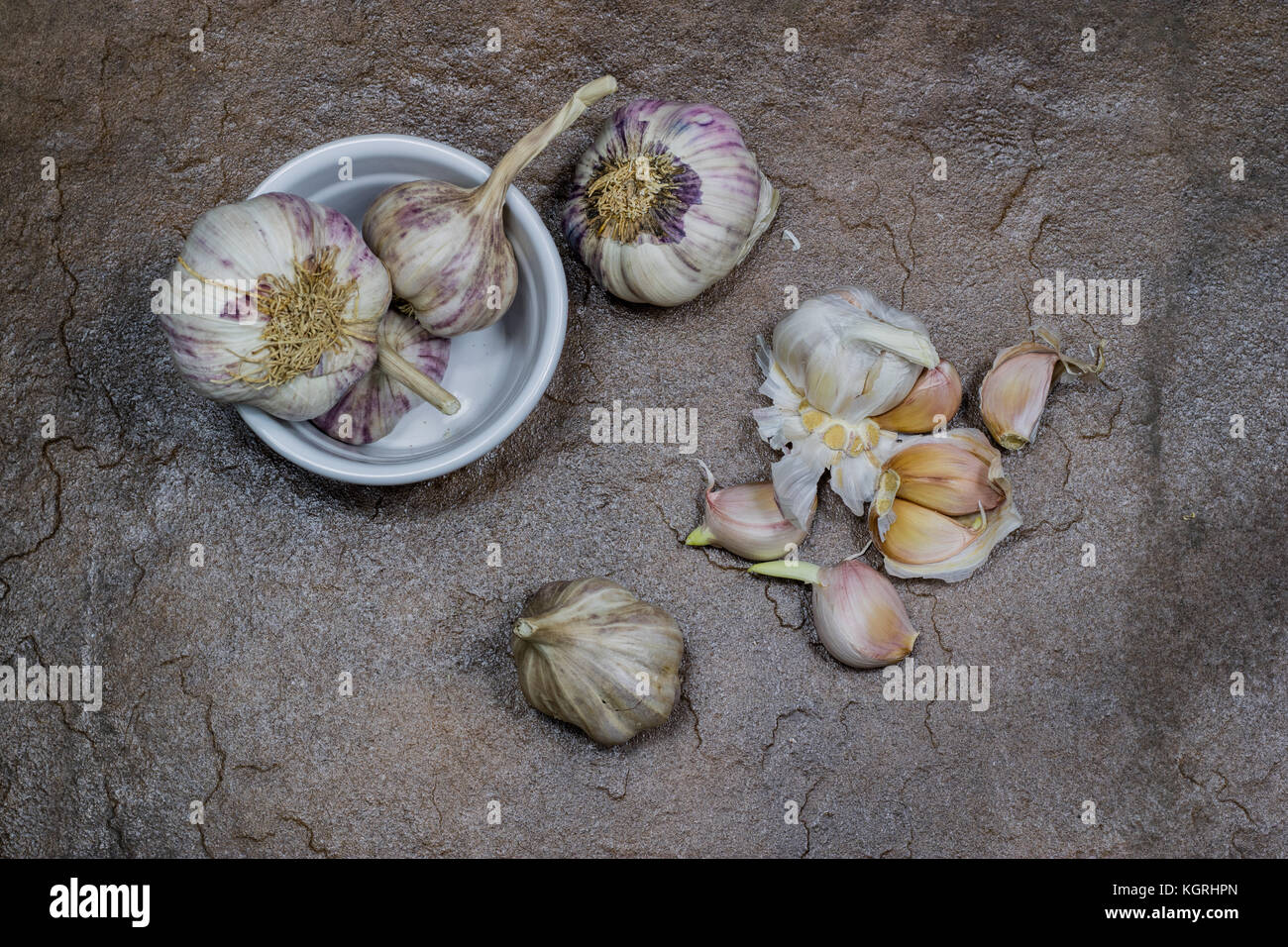 garlic and spices on a stone table in the kitchen. Healthy and fragrant ...