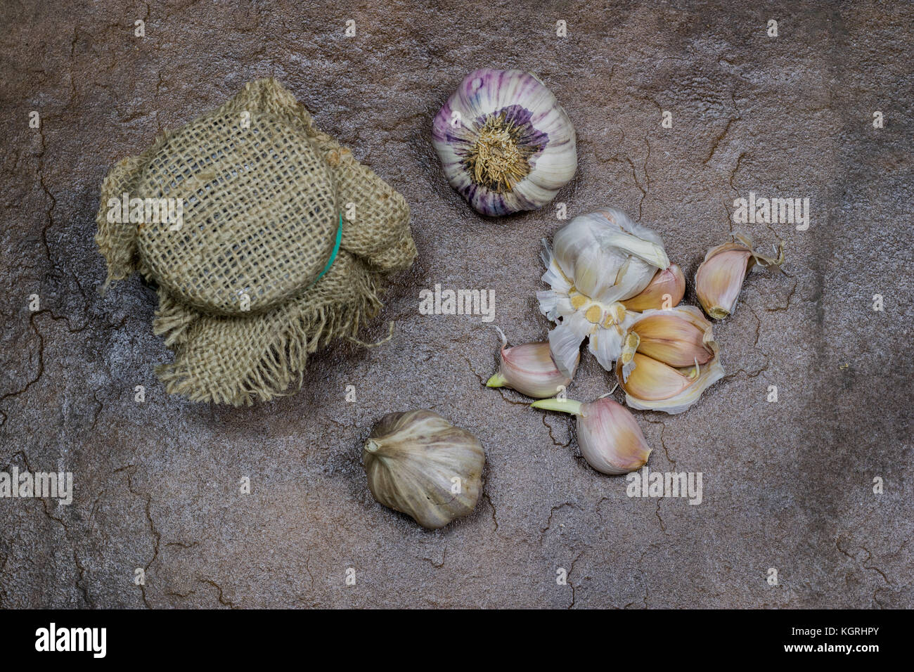 garlic and spices on a stone table in the kitchen. Healthy and fragrant ...