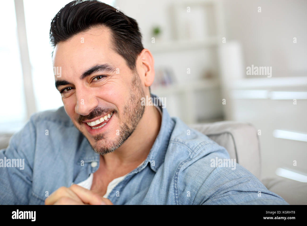 Handsome middle-aged man relaxing in sofa Stock Photo - Alamy