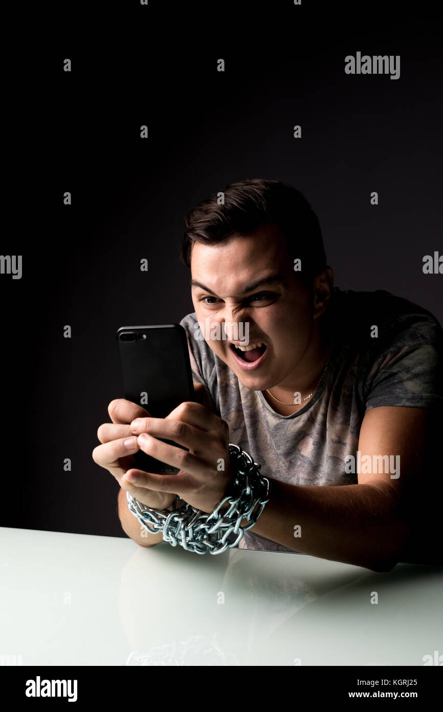 Man suffering from phone dependence addiction in dark room Stock Photo ...