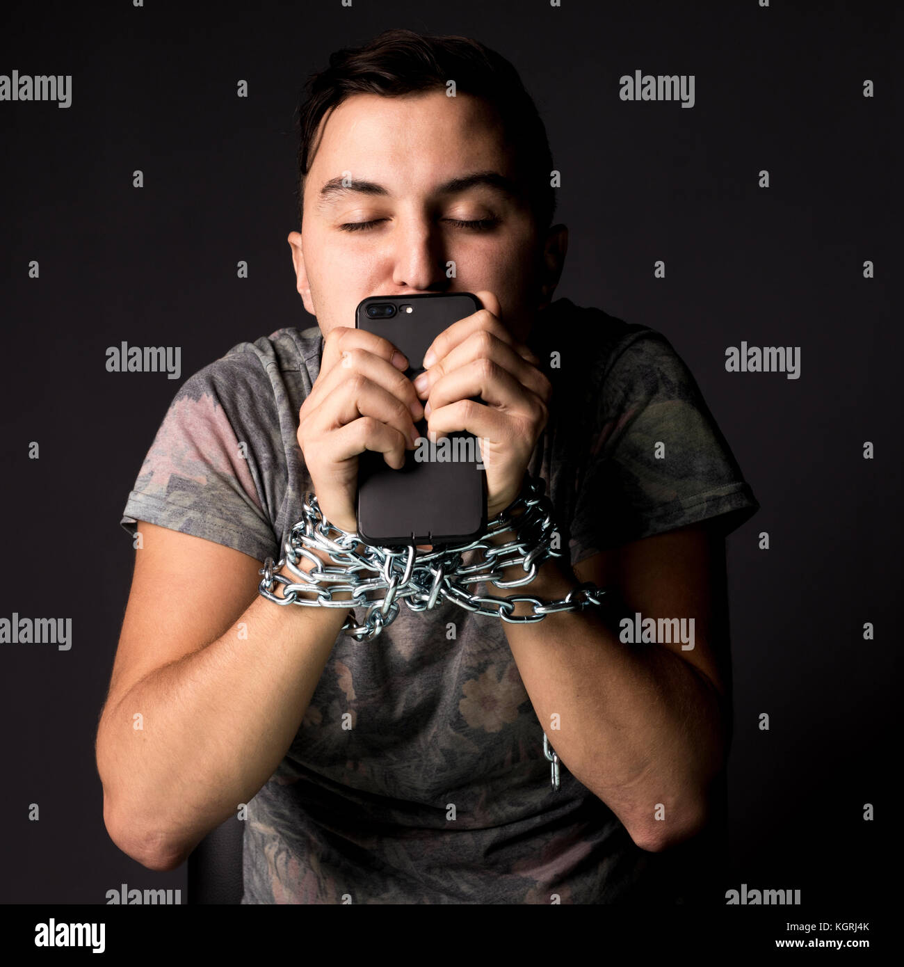 Young Man suffering from phone dependence addiction kiss phone with ...