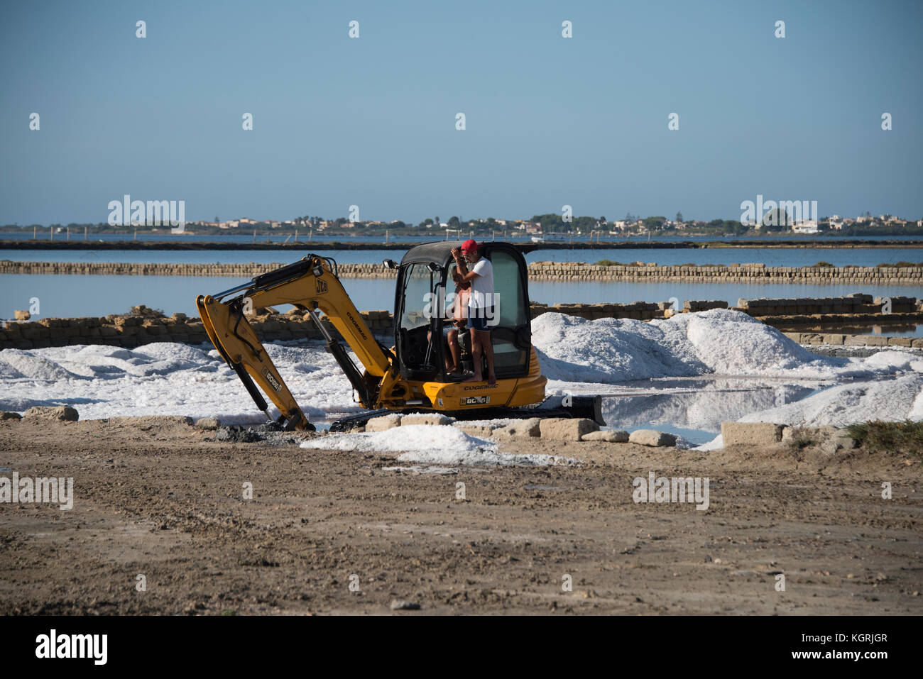 Excavators digging salt from a salt pool, Motya, Marsala, Sicily Stock ...