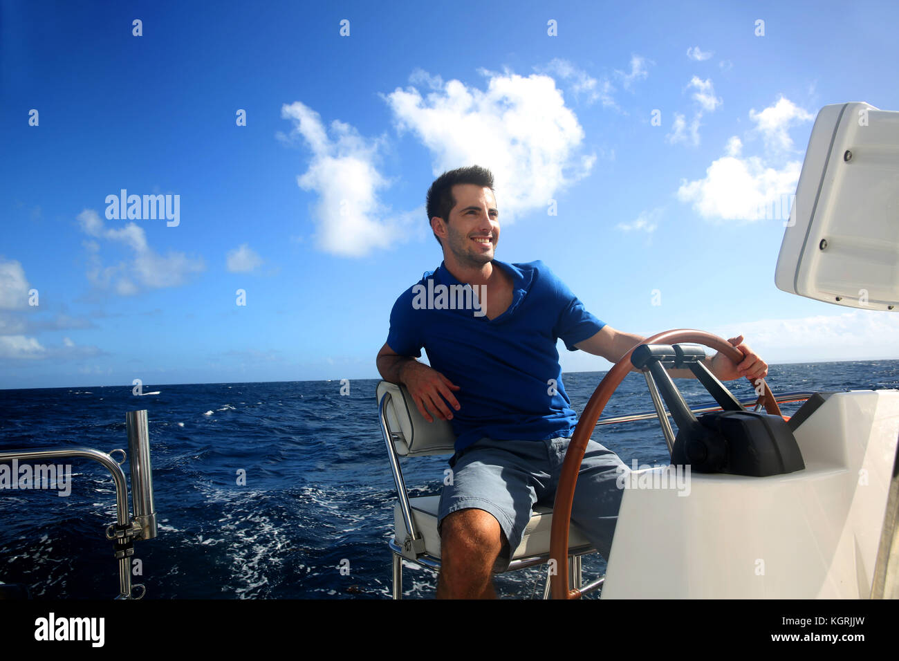 Smiling young sailor navigating in Caribbean sea Stock Photo - Alamy