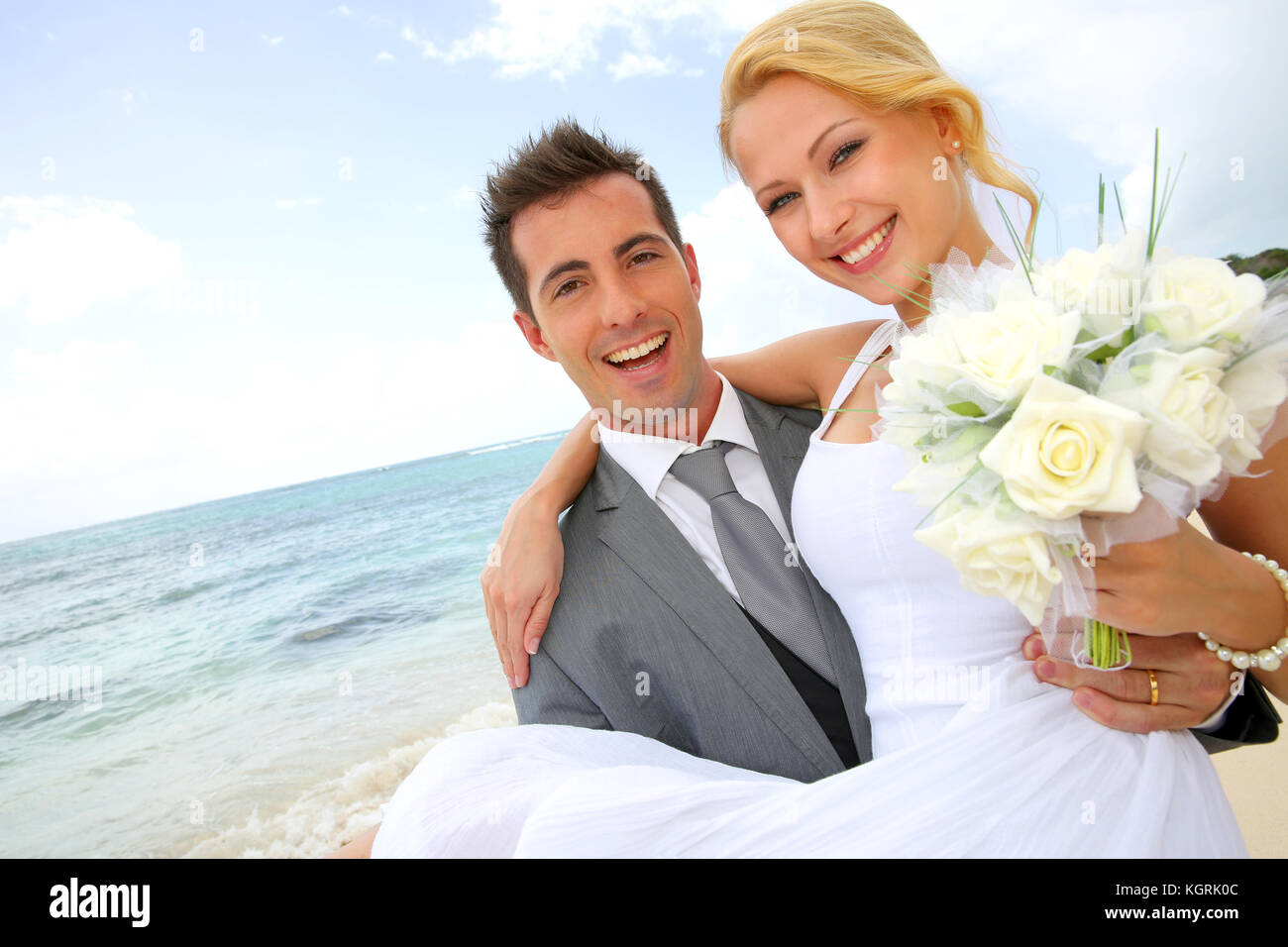 Groom carrying bride in arms hi-res stock photography and images - Alamy