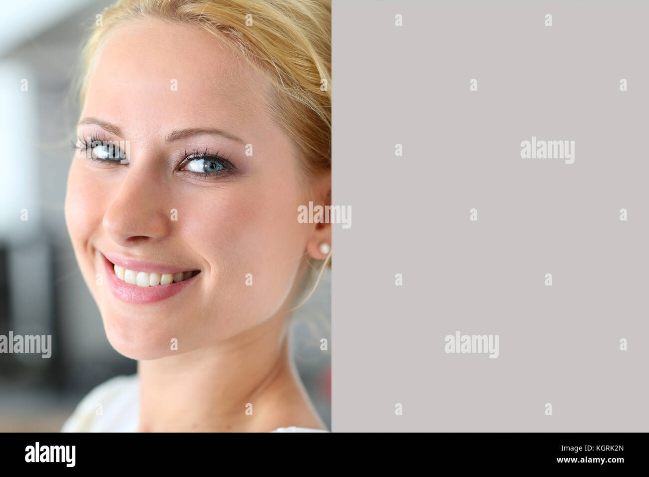 Attractive woman smiling at camera Stock Photo - Alamy
