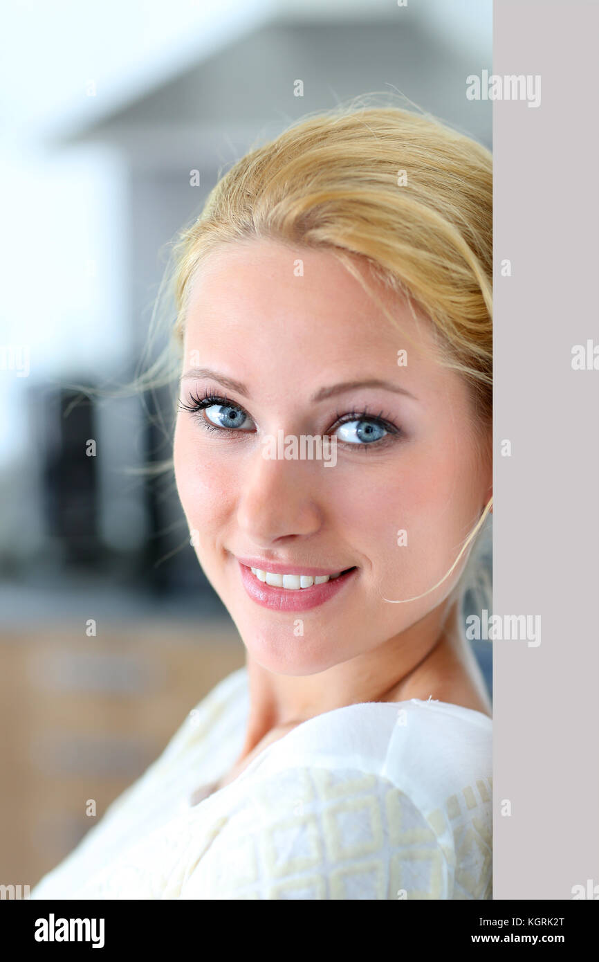 Attractive woman smiling at camera Stock Photo - Alamy