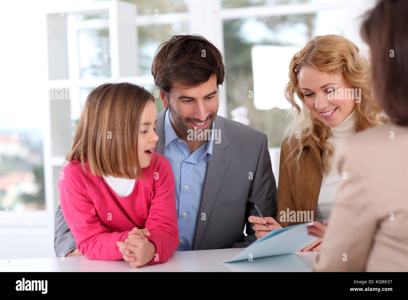 Family signing real-estate contract Stock Photo - Alamy