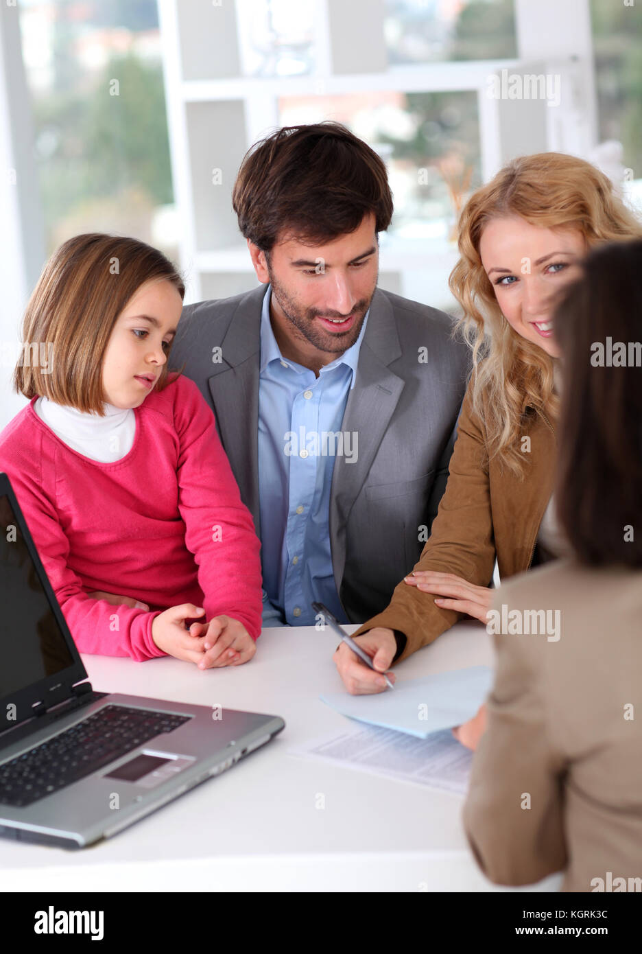 Family signing real-estate contract Stock Photo - Alamy