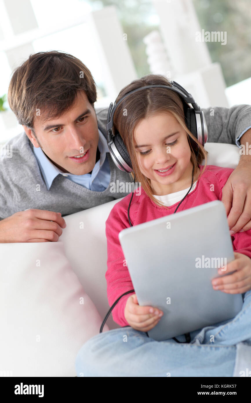 Father and daughter listening to music Stock Photo - Alamy