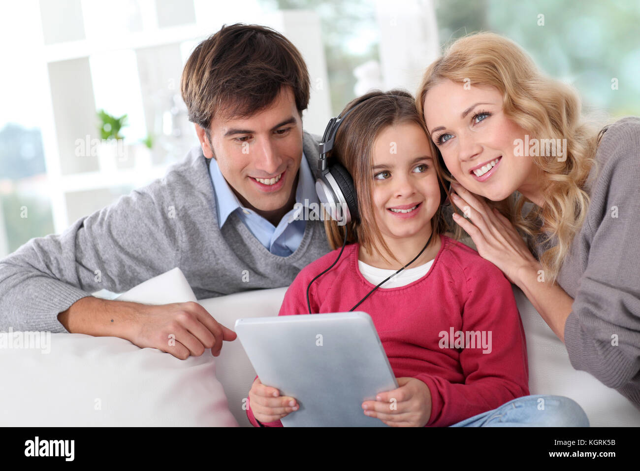 Family listening to music with tablet Stock Photo - Alamy
