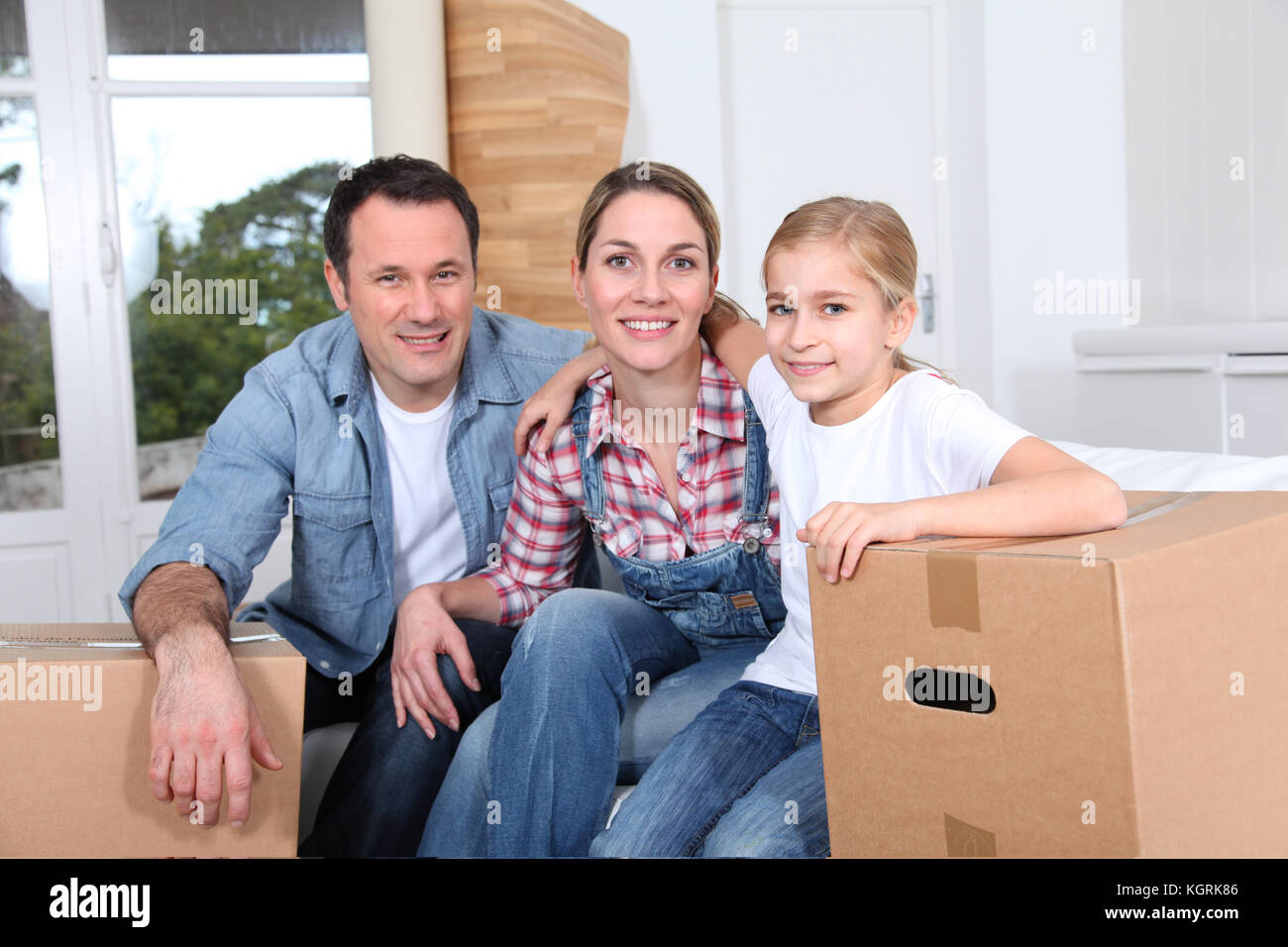 Happy family moving in new house Stock Photo - Alamy