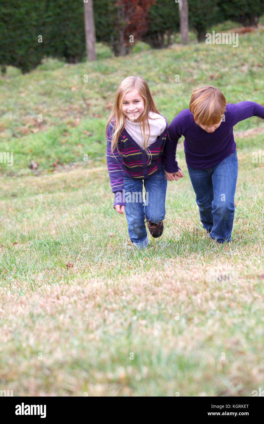 Kids having fun running in park Stock Photo - Alamy