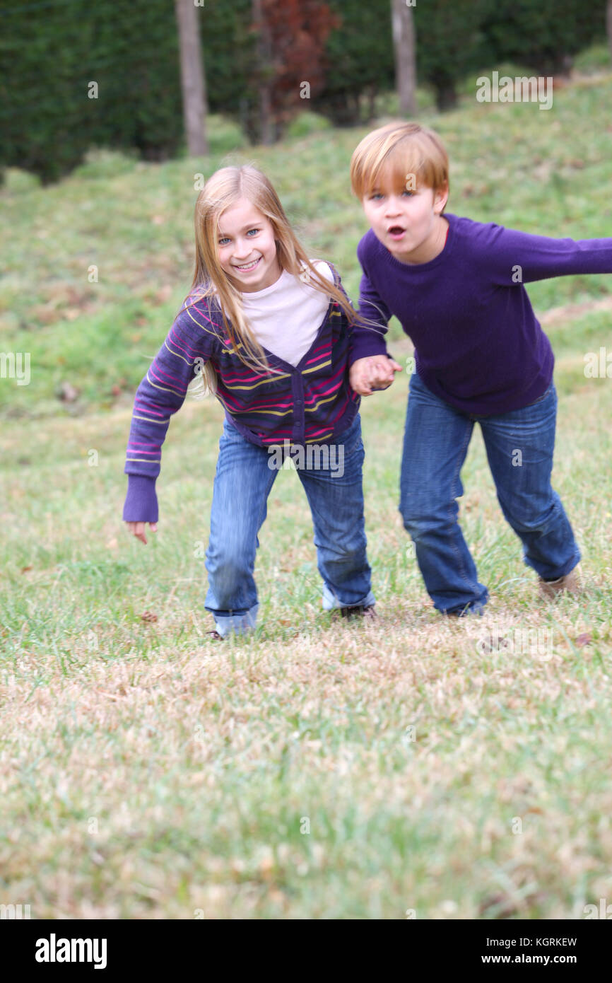 Kids having fun running in park Stock Photo - Alamy
