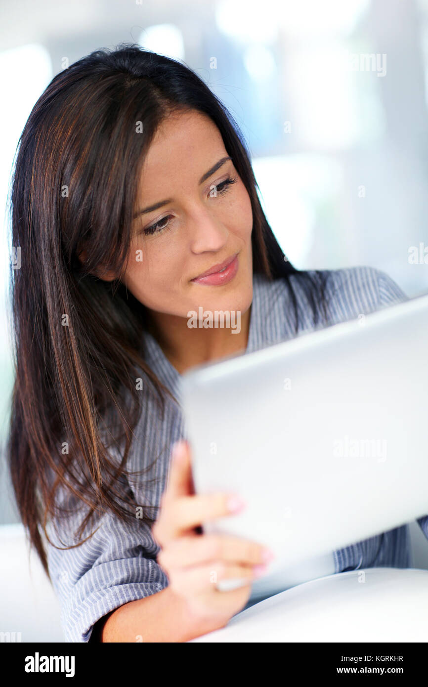 Young woman at home using electronic tablet Stock Photo - Alamy