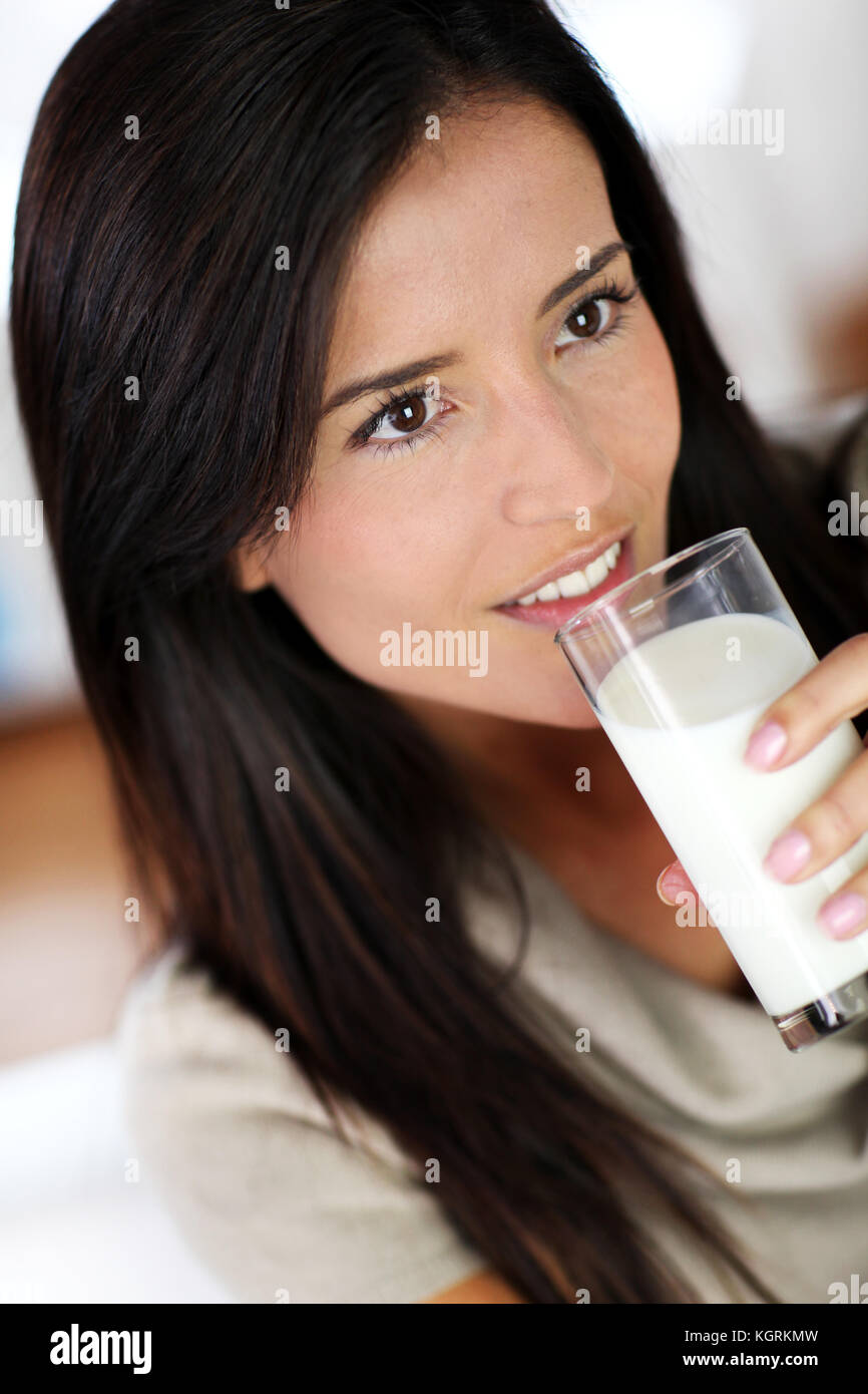 Attractive young woman drinking fresh milk Stock Photo - Alamy