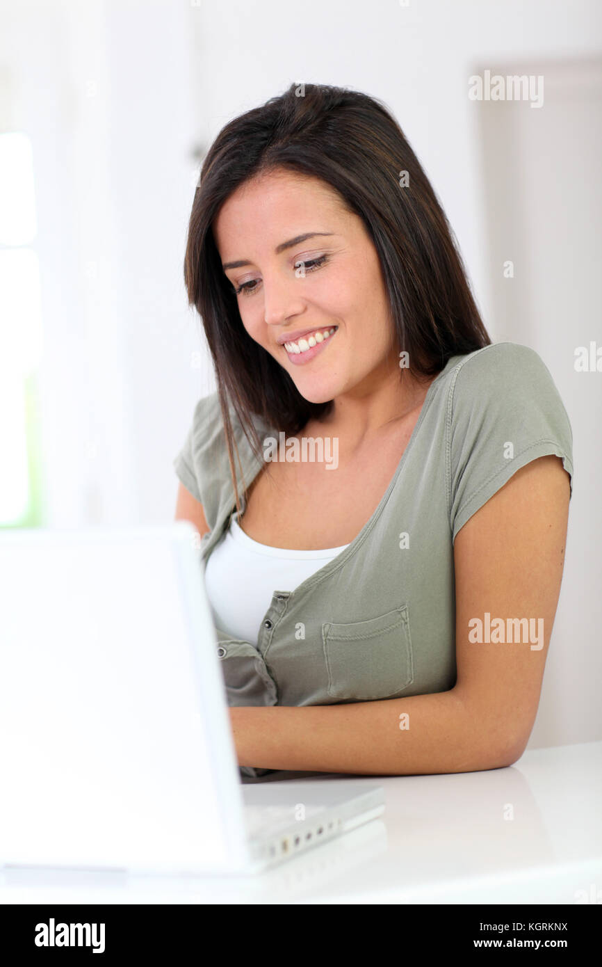 Beautiful young woman working at home on laptop computer Stock Photo ...