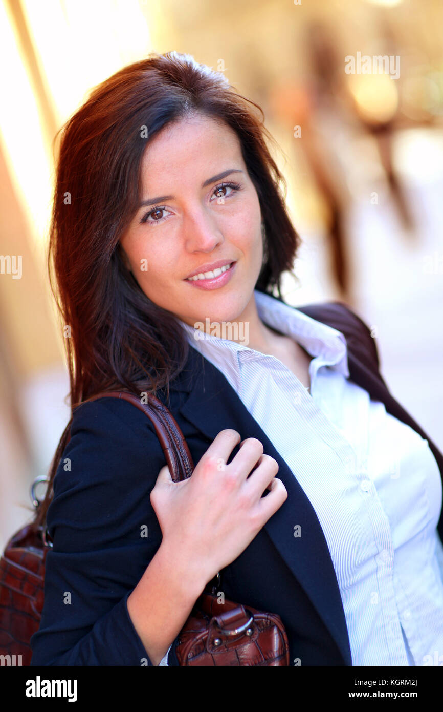 Young woman walking in town Stock Photo - Alamy
