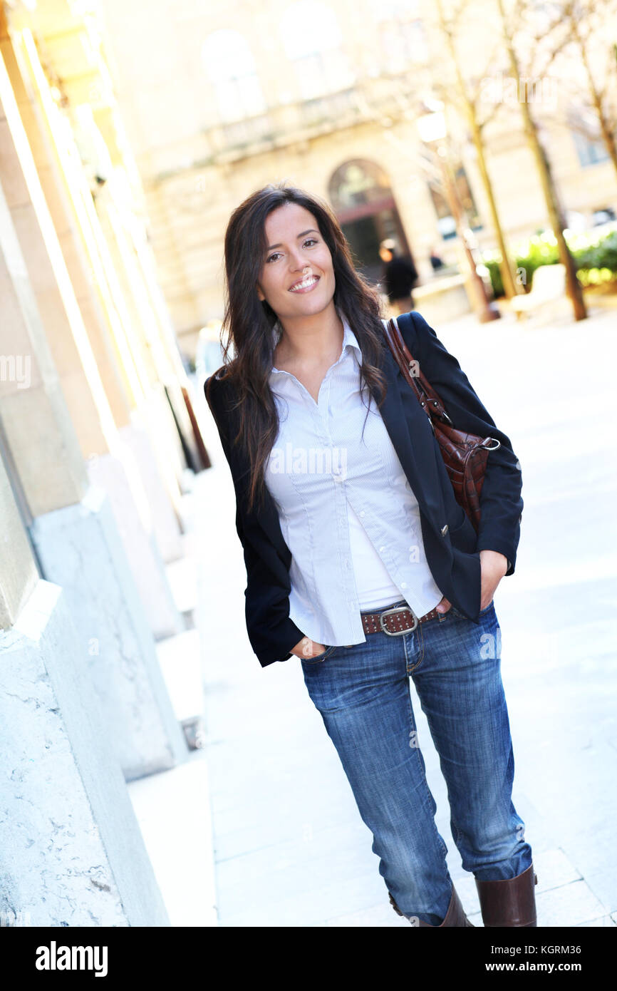 Beautiful woman walking in town Stock Photo - Alamy