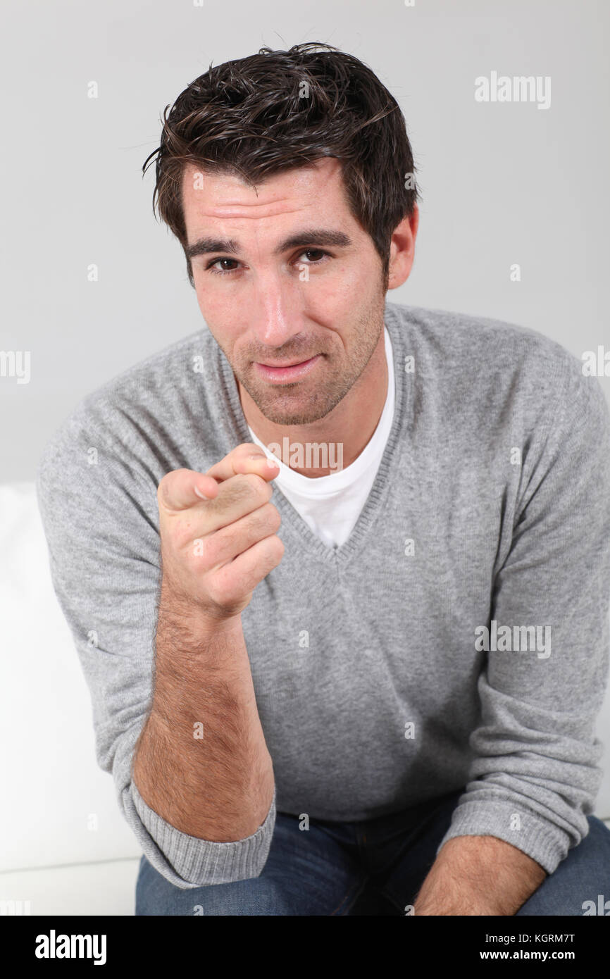 Portrait of handsome man pointing at camera Stock Photo - Alamy