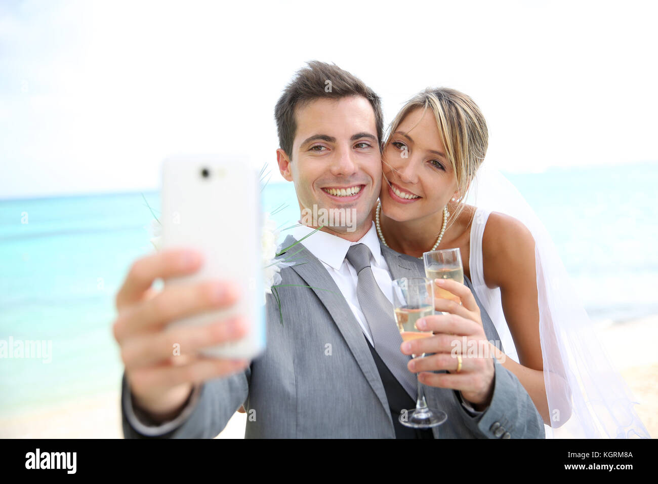 Married couple taking picture with smartphone Stock Photo - Alamy