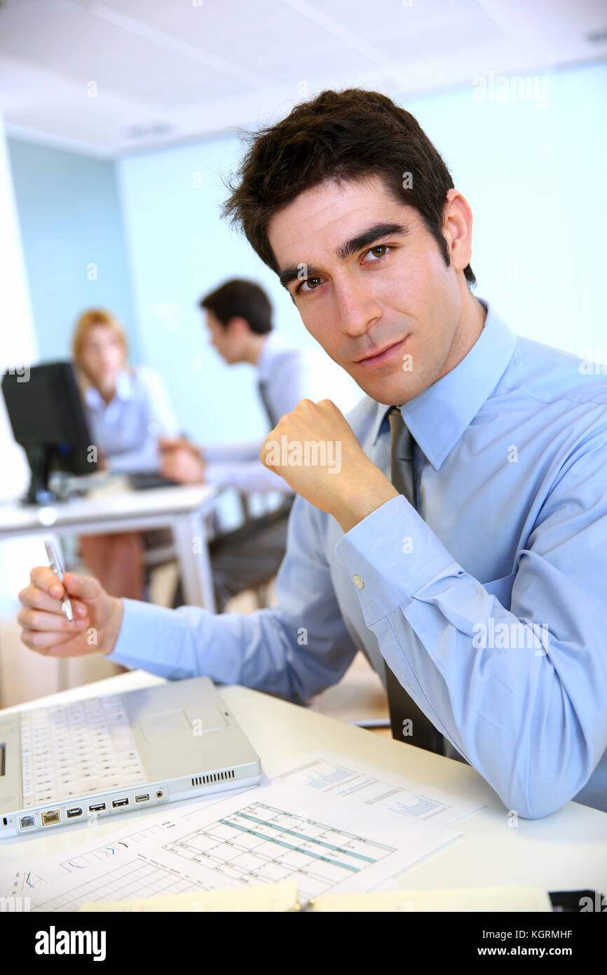 Cheerful salesman working on laptop computer Stock Photo - Alamy