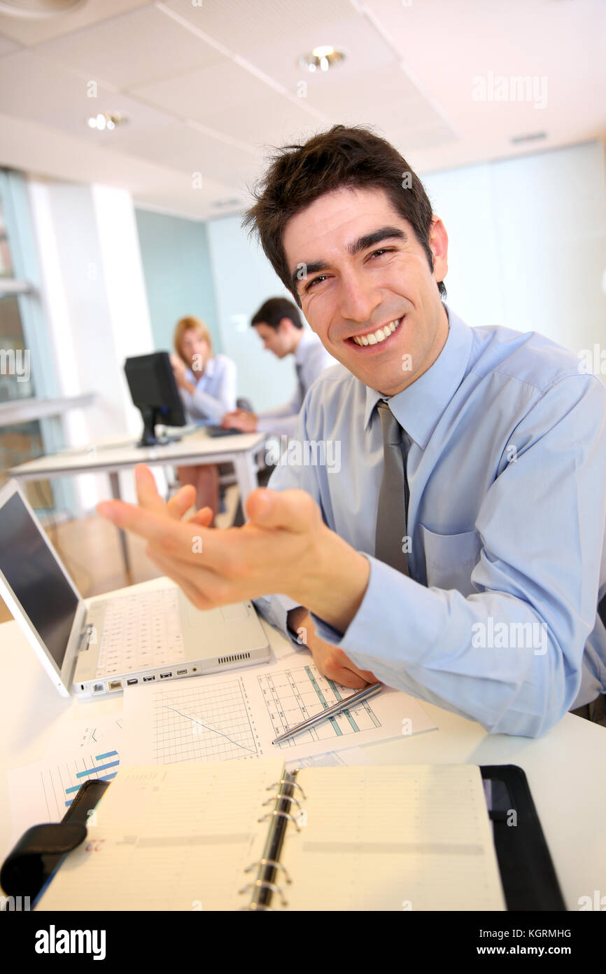 Cheerful salesman working on laptop computer Stock Photo - Alamy