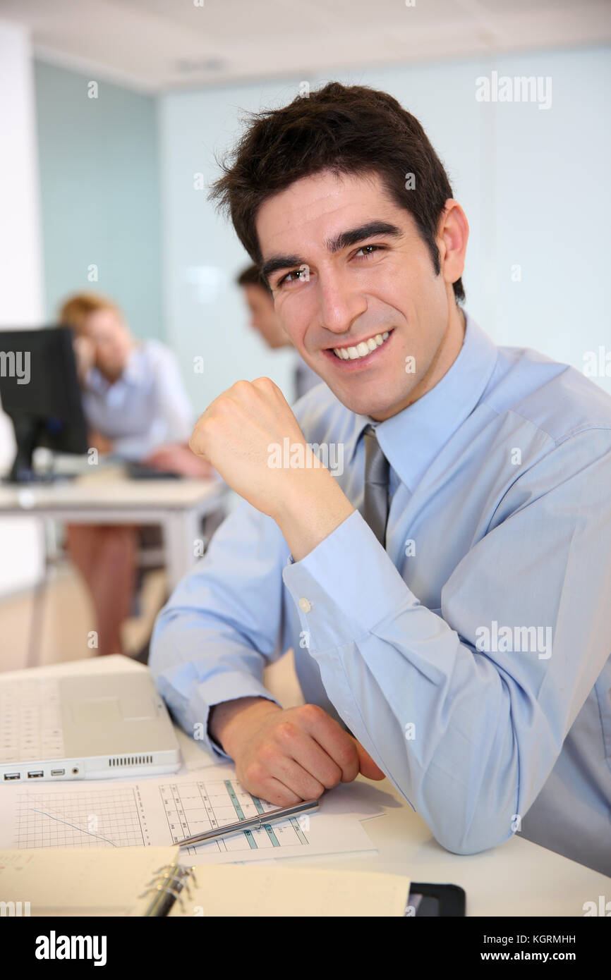 Cheerful salesman working on laptop computer Stock Photo - Alamy