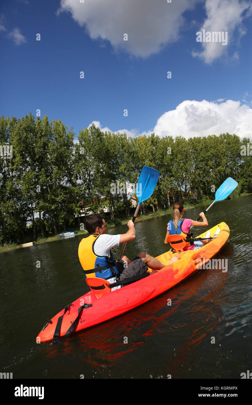 Couple riding canoe in river Stock Photo - Alamy