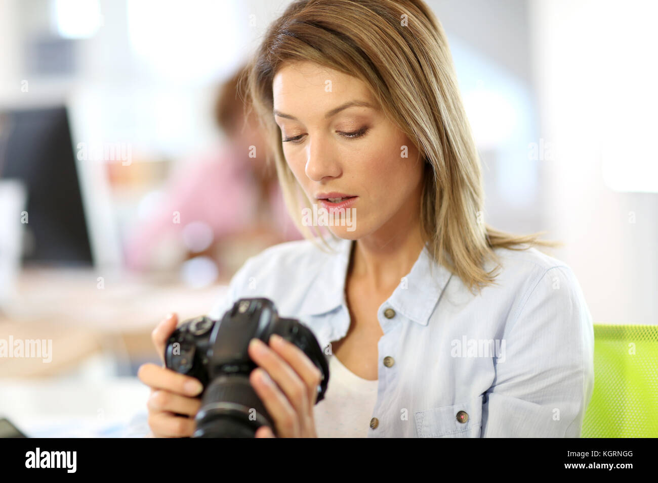 Looking at camera sitting smiling journalist hi-res stock photography ...