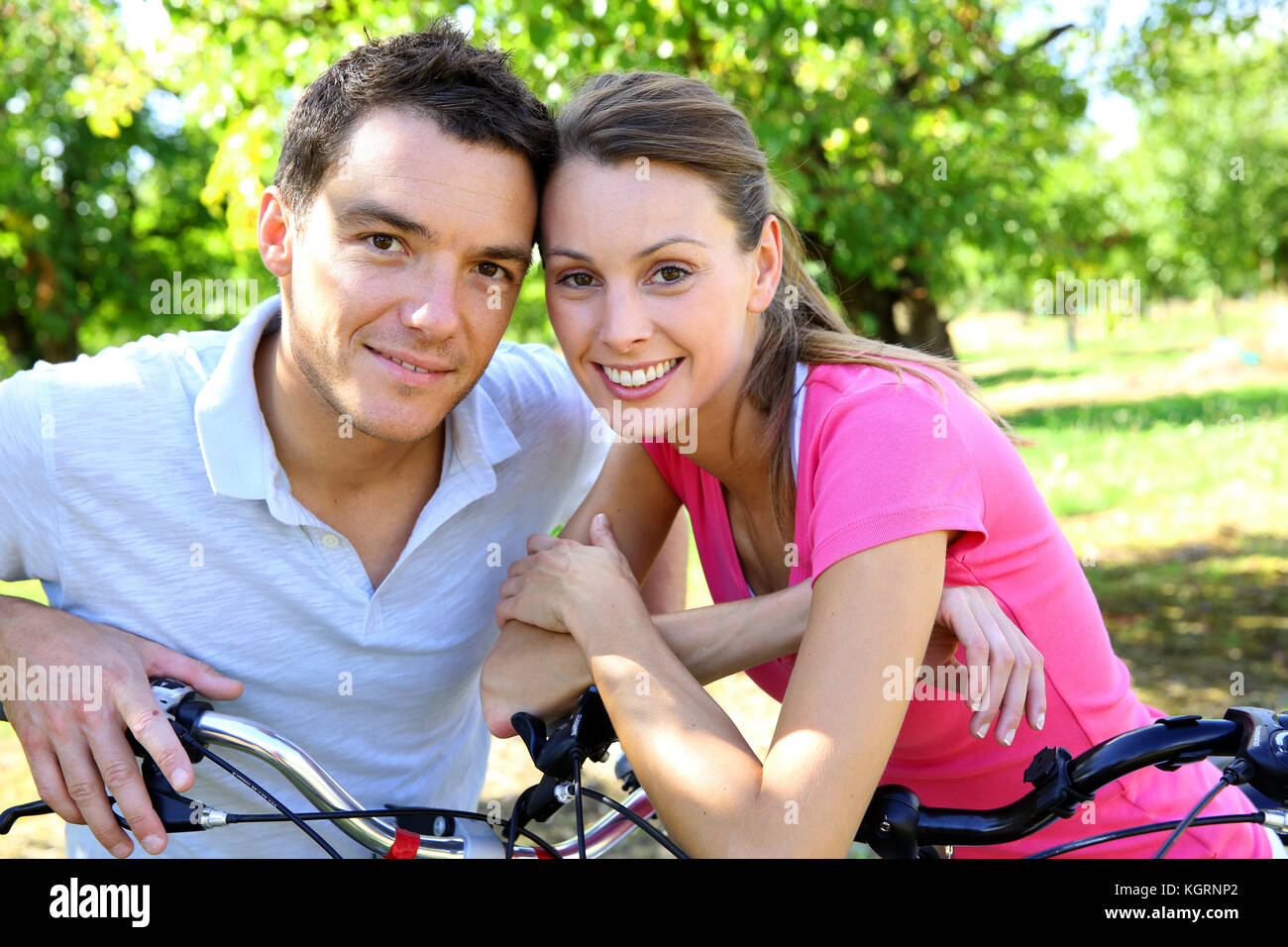 Portrait of cheerful couple on a bike ride Stock Photo - Alamy