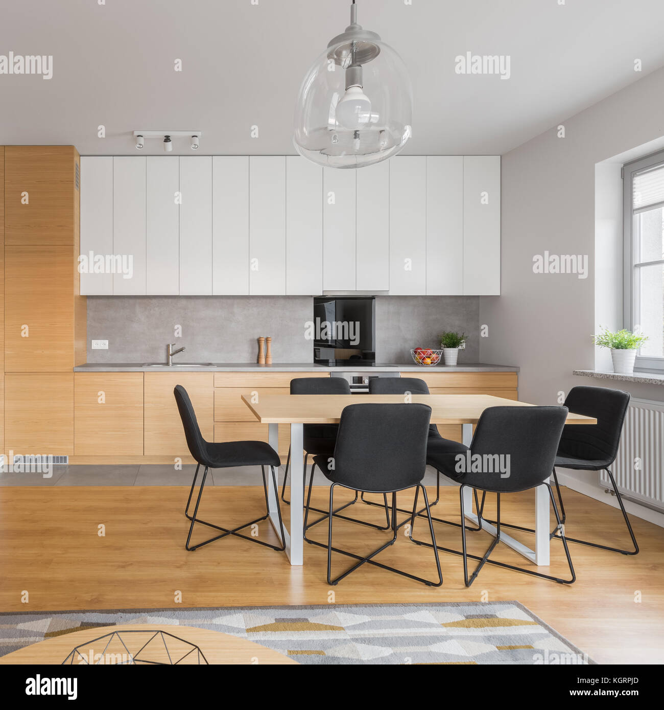 Modern kitchen with wooden furniture and dining table Stock Photo - Alamy